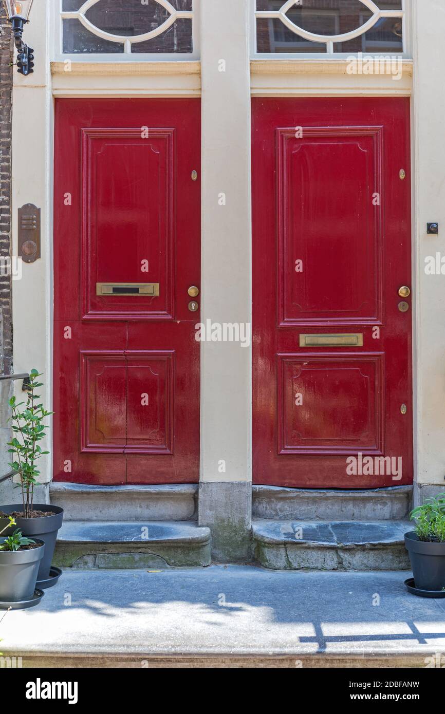 Two Red Doors Home Entrance in Amsterdam Stock Photo - Alamy