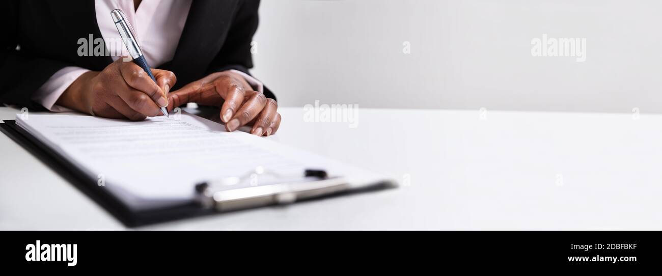 Businesswoman filling contract form hi-res stock photography and images ...