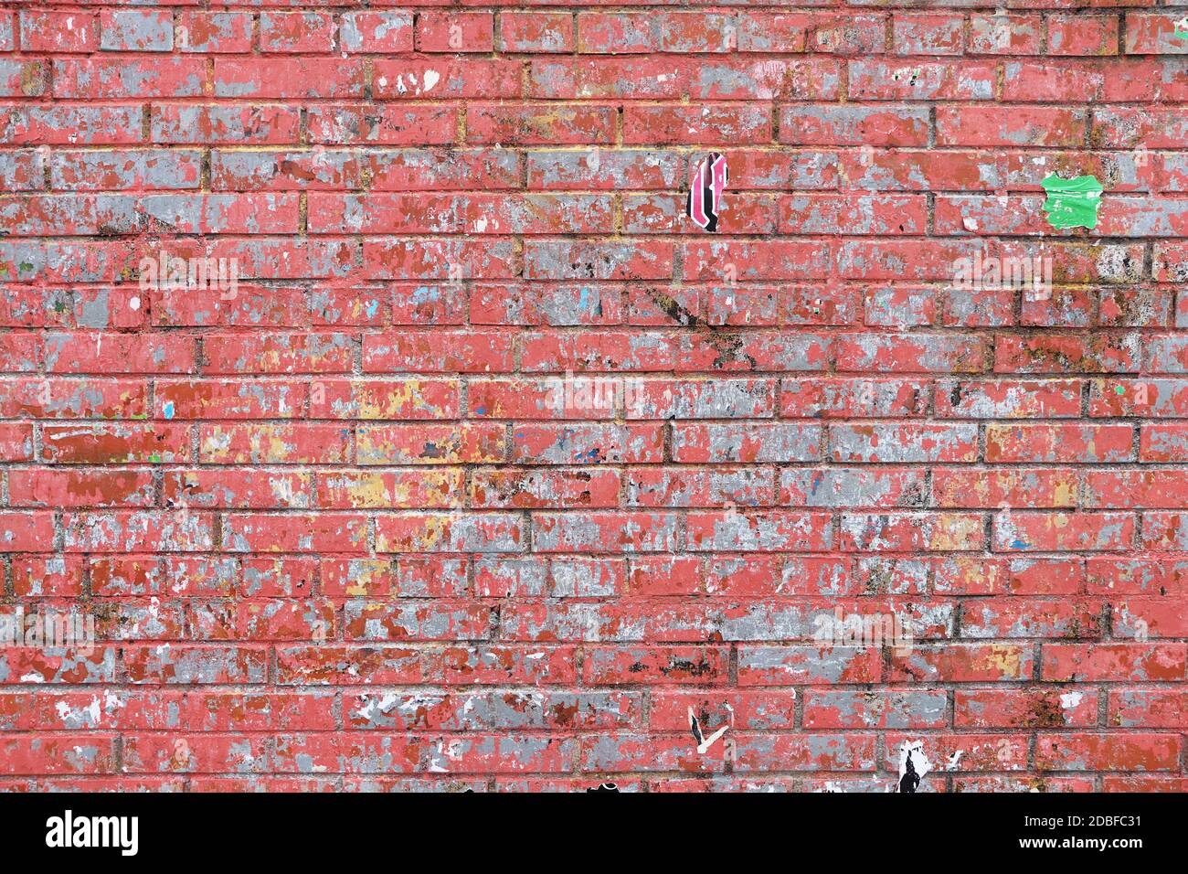 Red brick with remnants of pasted posters. Wall texture Stock Photo - Alamy