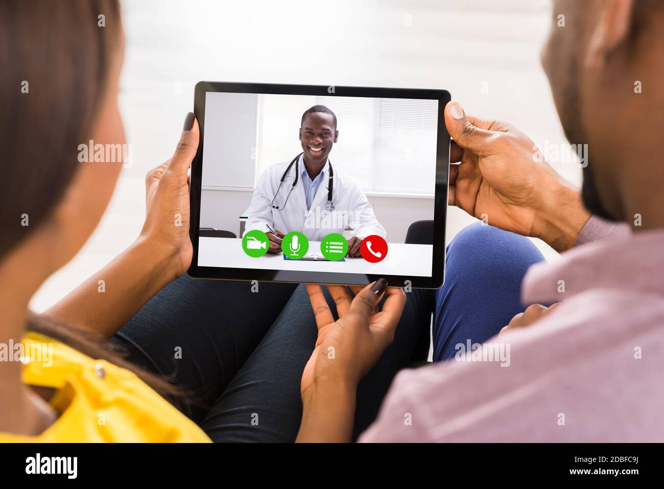 Pregnant Couple In Online Video Conference Call With Doctor Stock Photo ...