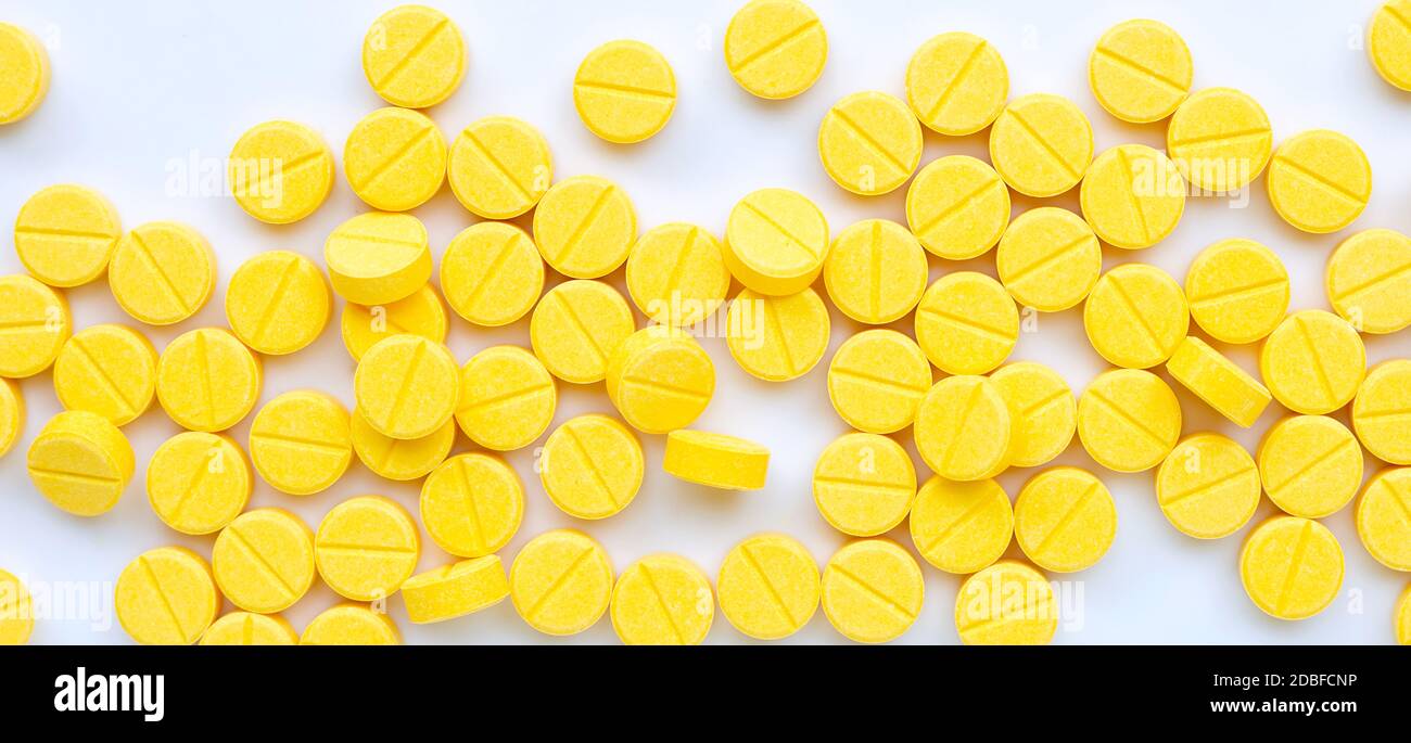 Yellow tablets of Paracetamol on white background. Top view Stock Photo ...