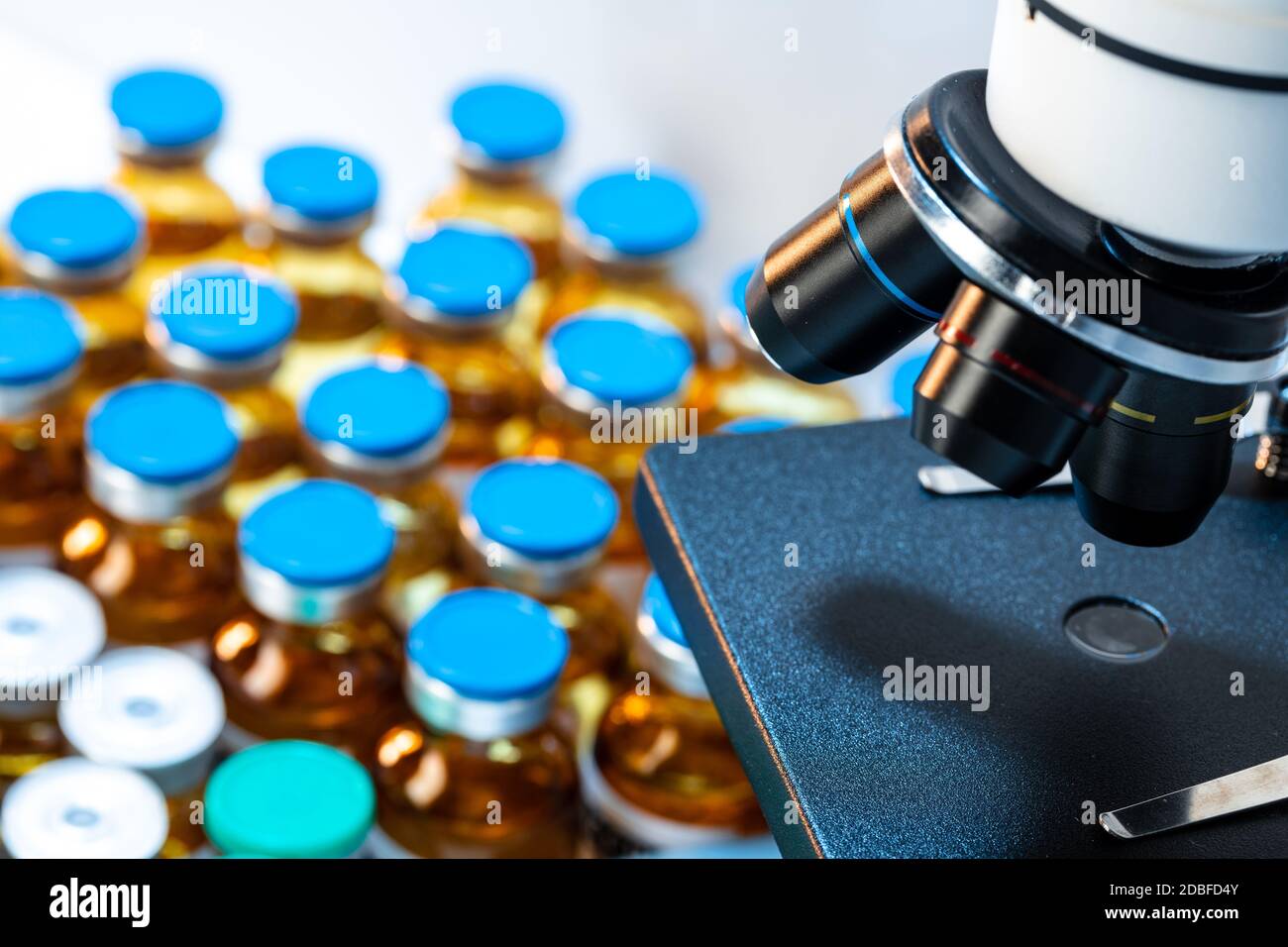 Medical vial with medication near microscope photo Stock Photo - Alamy