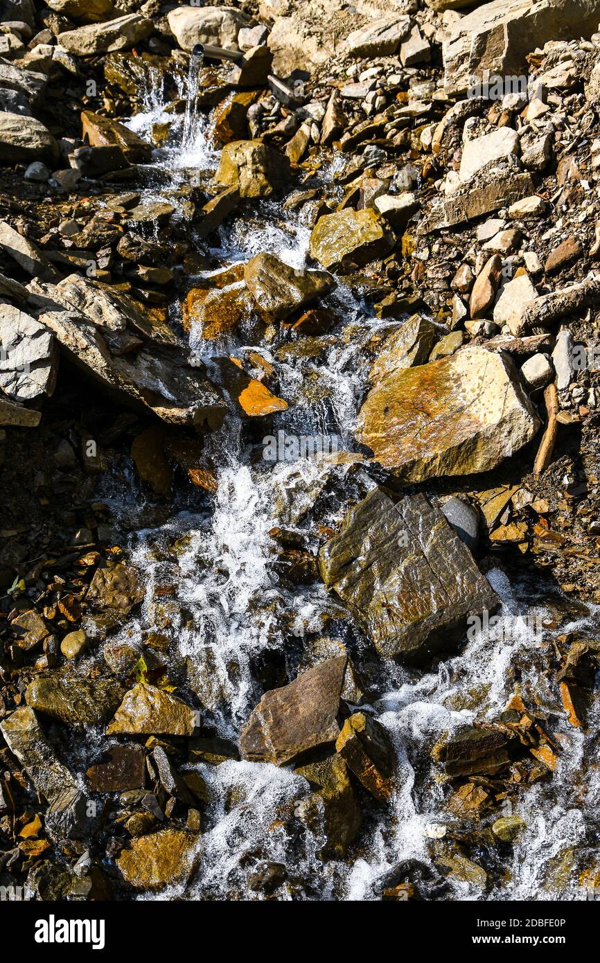Big and small stones near the stream. The mountains. The texture of the ...