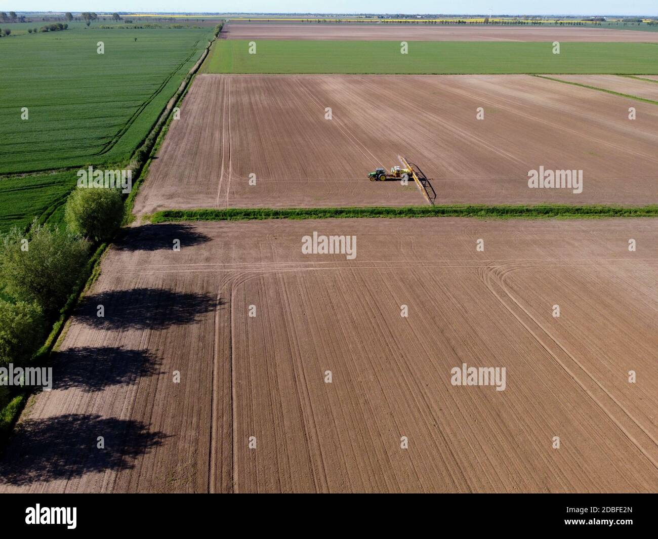 Tractor spraying fields in spring, Zulawy Wislane, Poland Stock Photo ...