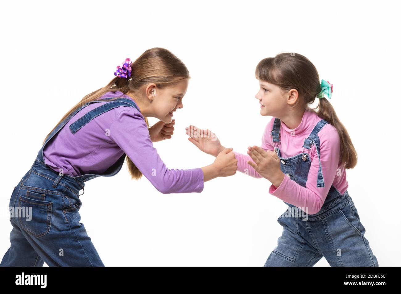 two girls quarrel and fight with each other on a white background Stock ...