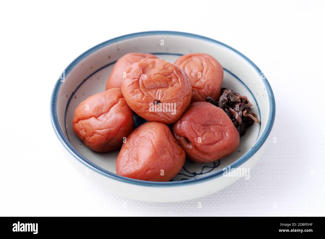 Japanese food, salted Umeboshi in a dish on white background Stock ...