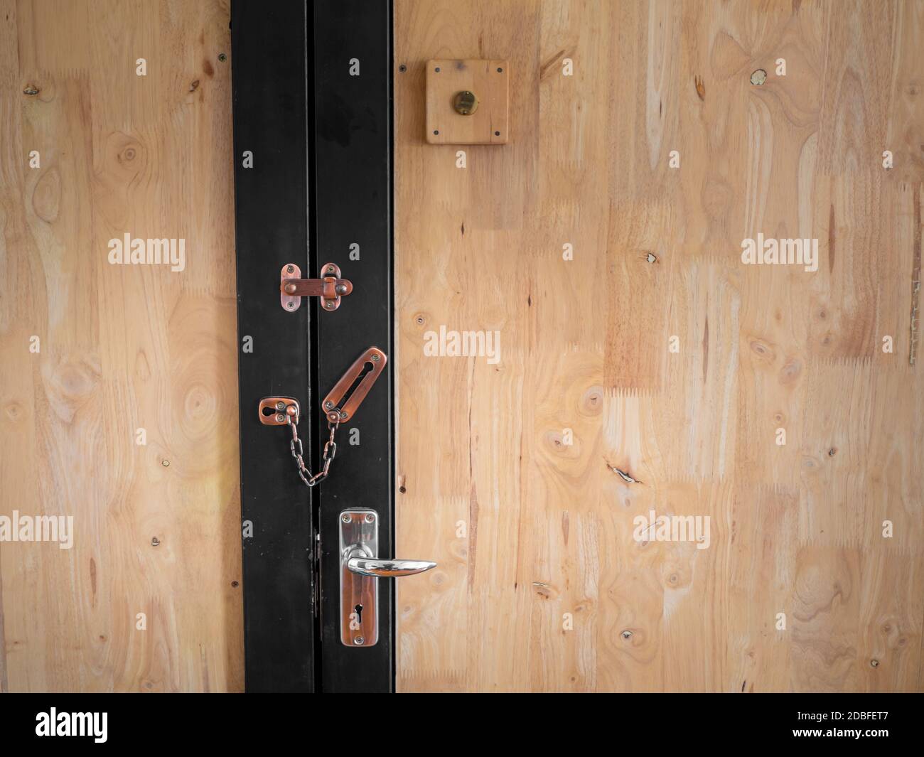New brown modern wooden door lock in house interior Stock Photo - Alamy