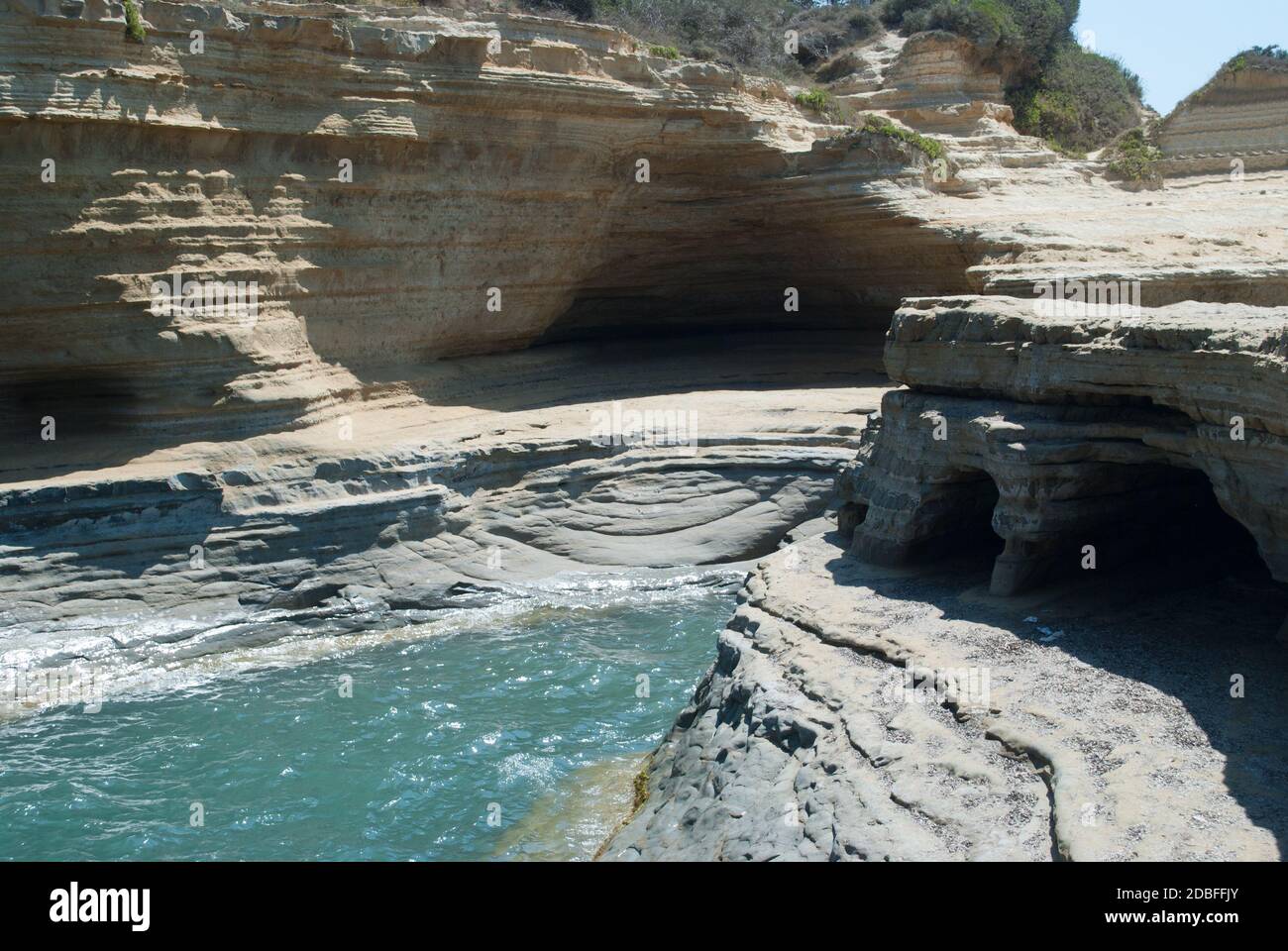 Natural stone cave on the beach of Corfu Stock Photo - Alamy