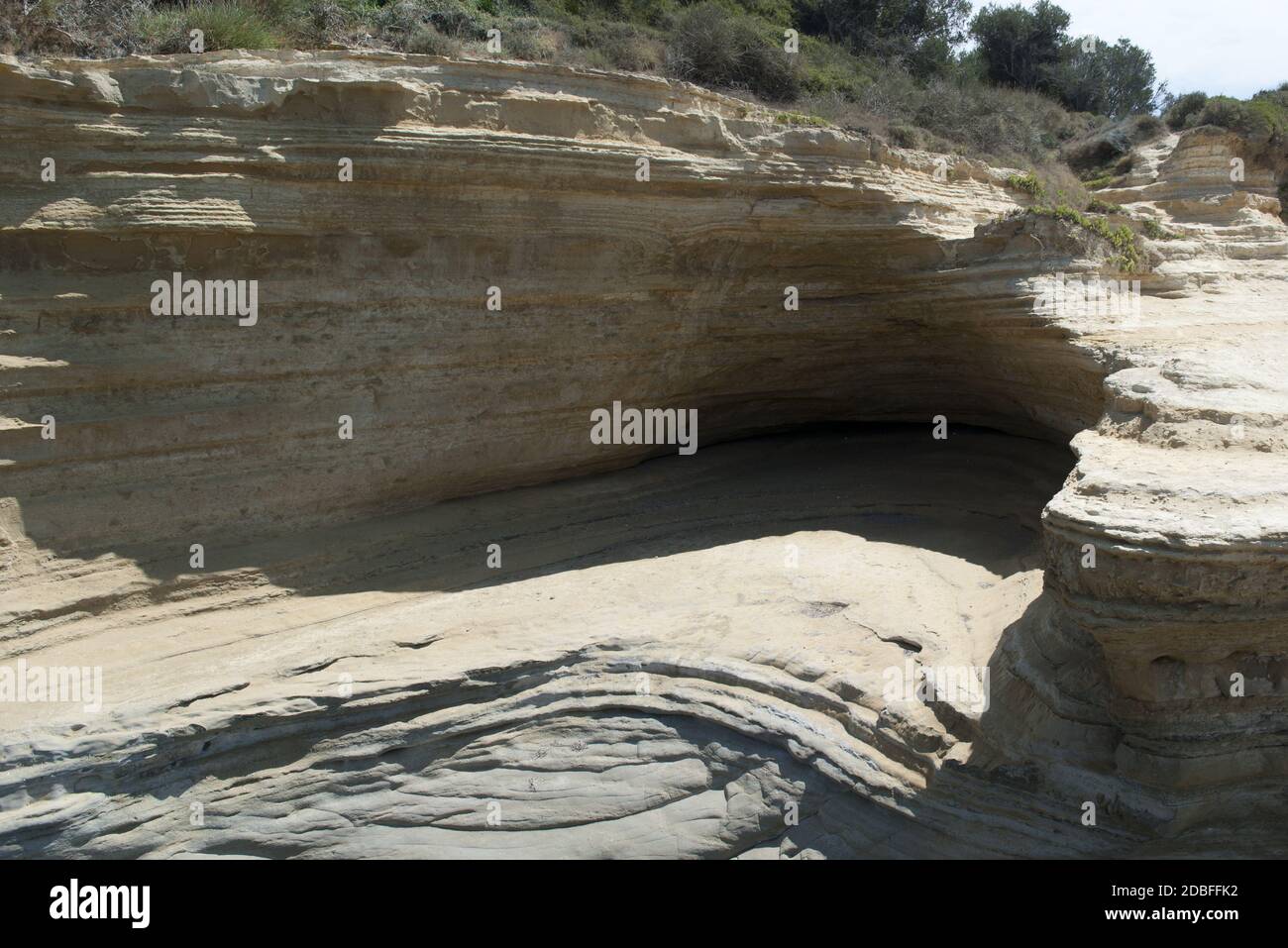 Natural stone cave on the beach of Corfu Stock Photo - Alamy