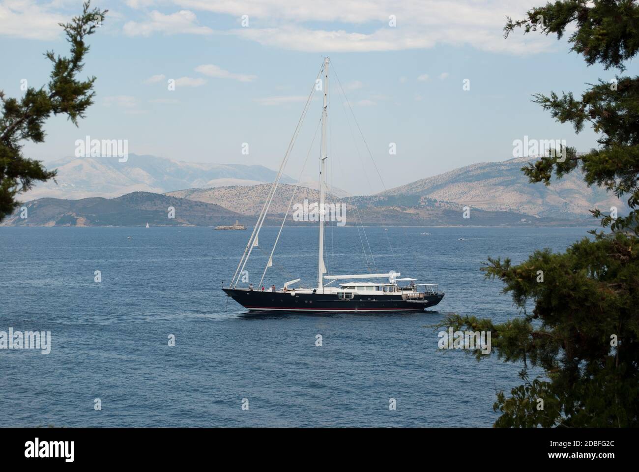 beautiful seascape sailing boat on a background of mountains Stock ...