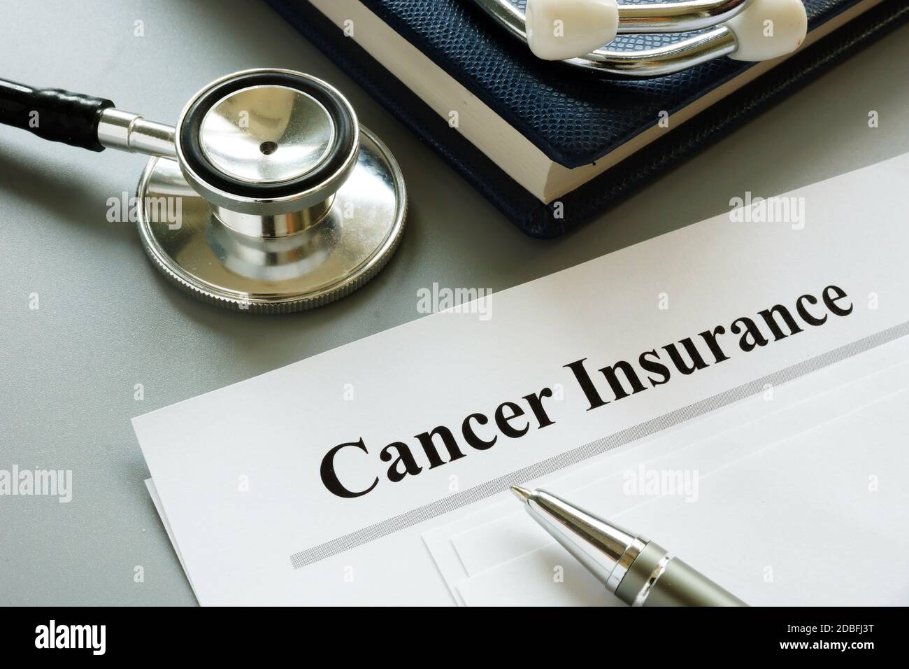 Cancer Insurance policy and stethoscope on a desk Stock Photo - Alamy