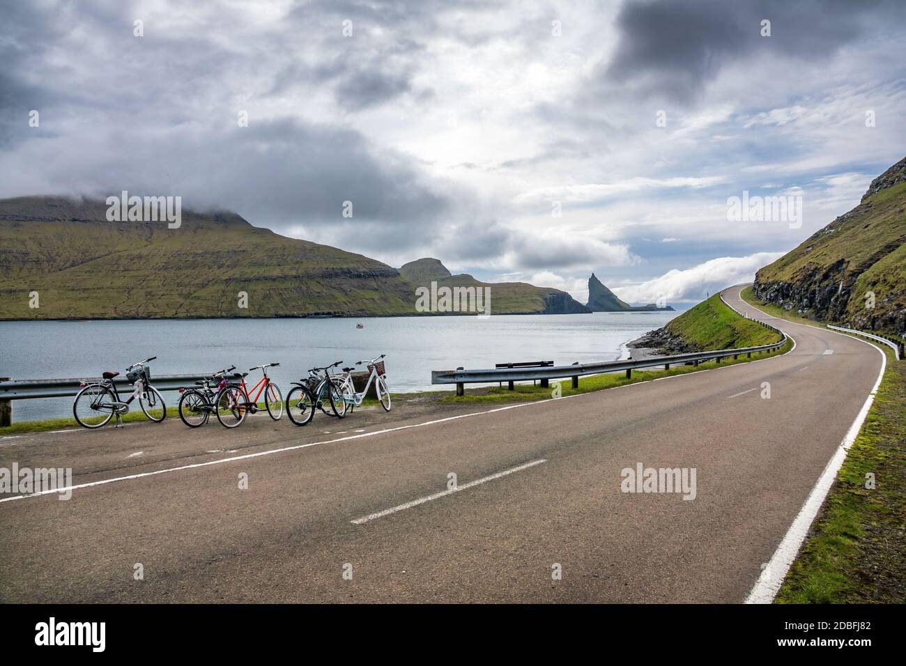 Bicycles parked near high slope iconic road in Faroe Islands Stock ...