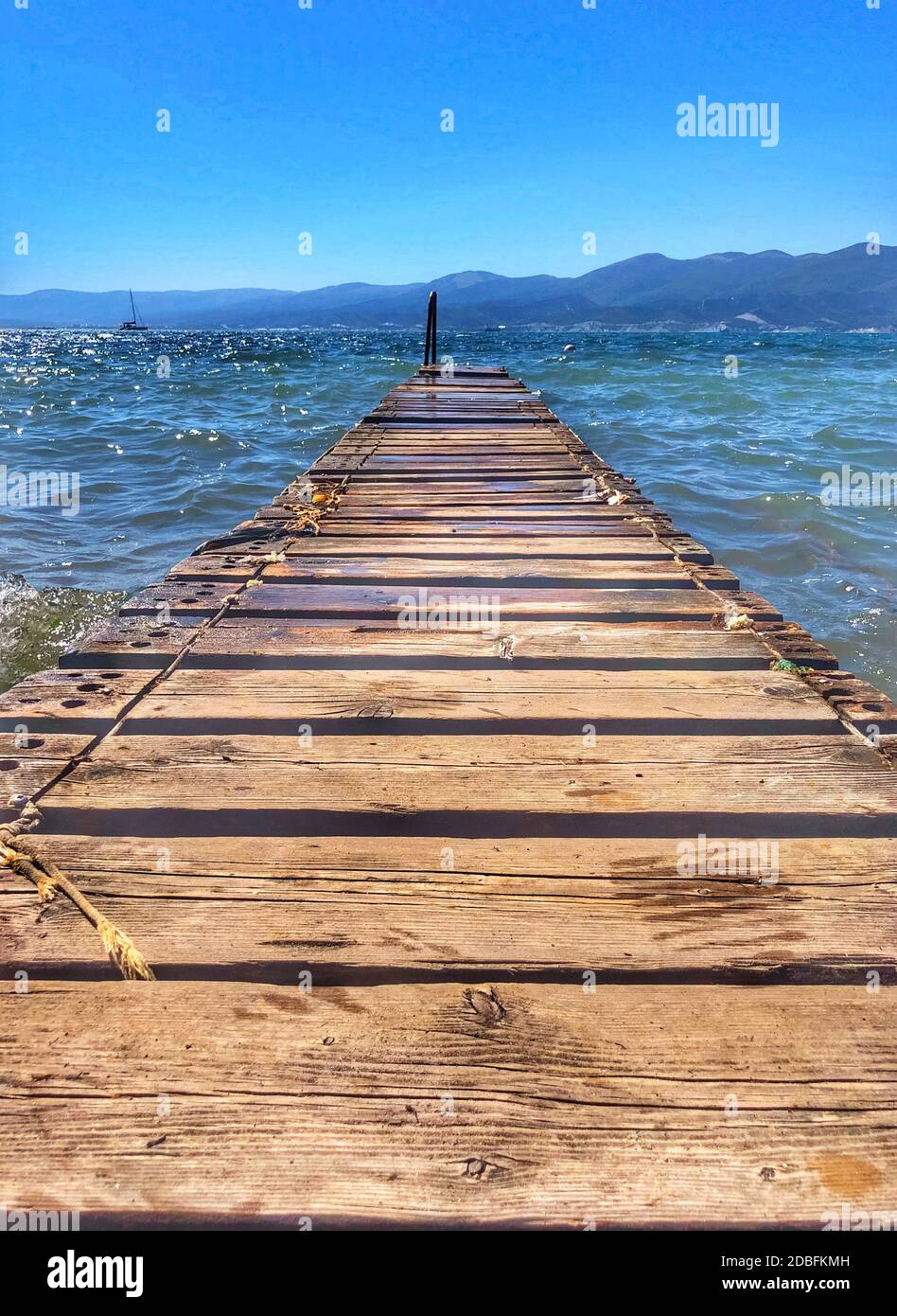 Wooden pier by the sea. Boards of the pier and sea waves Stock Photo ...