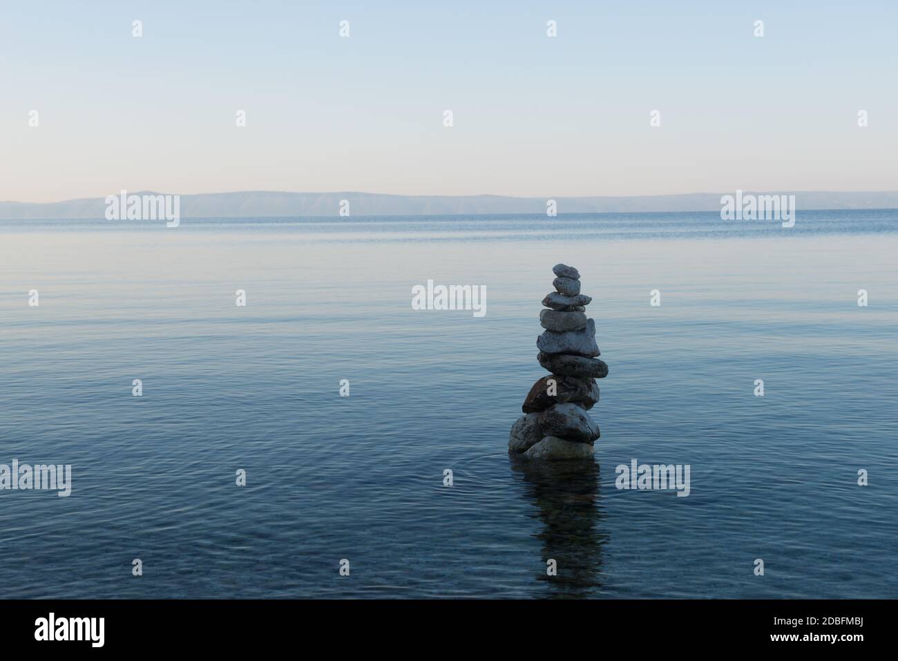Balance stone pyramid on the sea coast in Croatia Stock Photo - Alamy