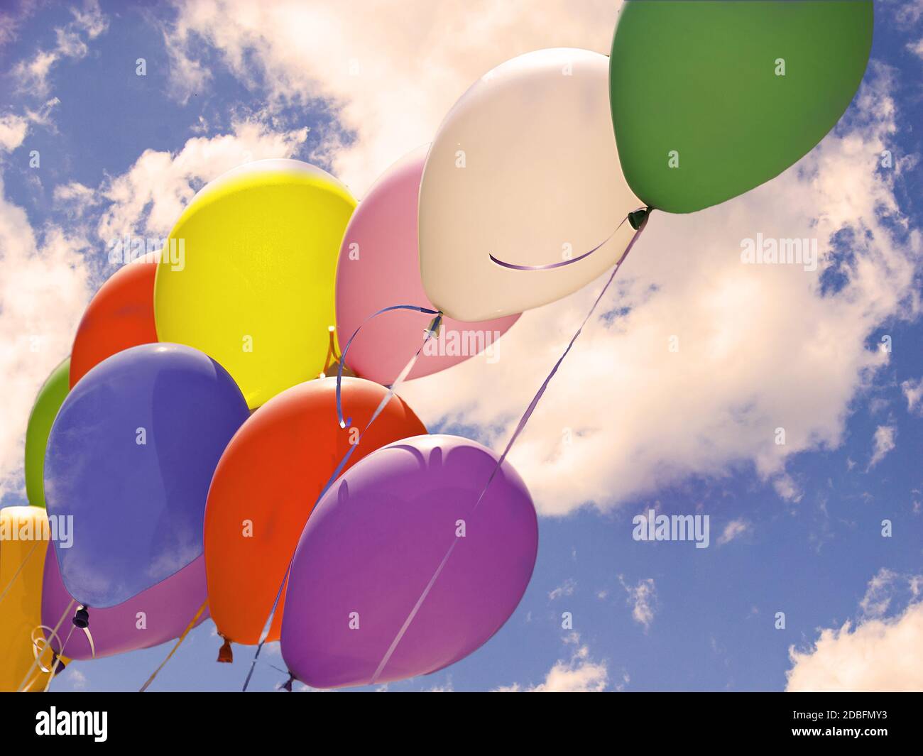 Colored balloons fly in the sunset sky Stock Photo - Alamy