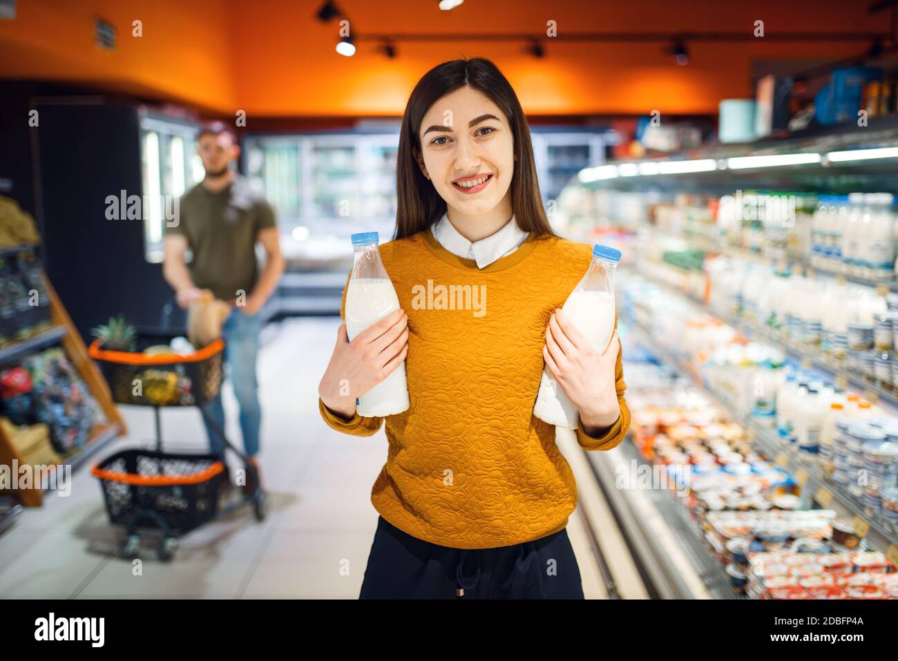 Woman buying milk product in hi-res stock photography and images - Alamy