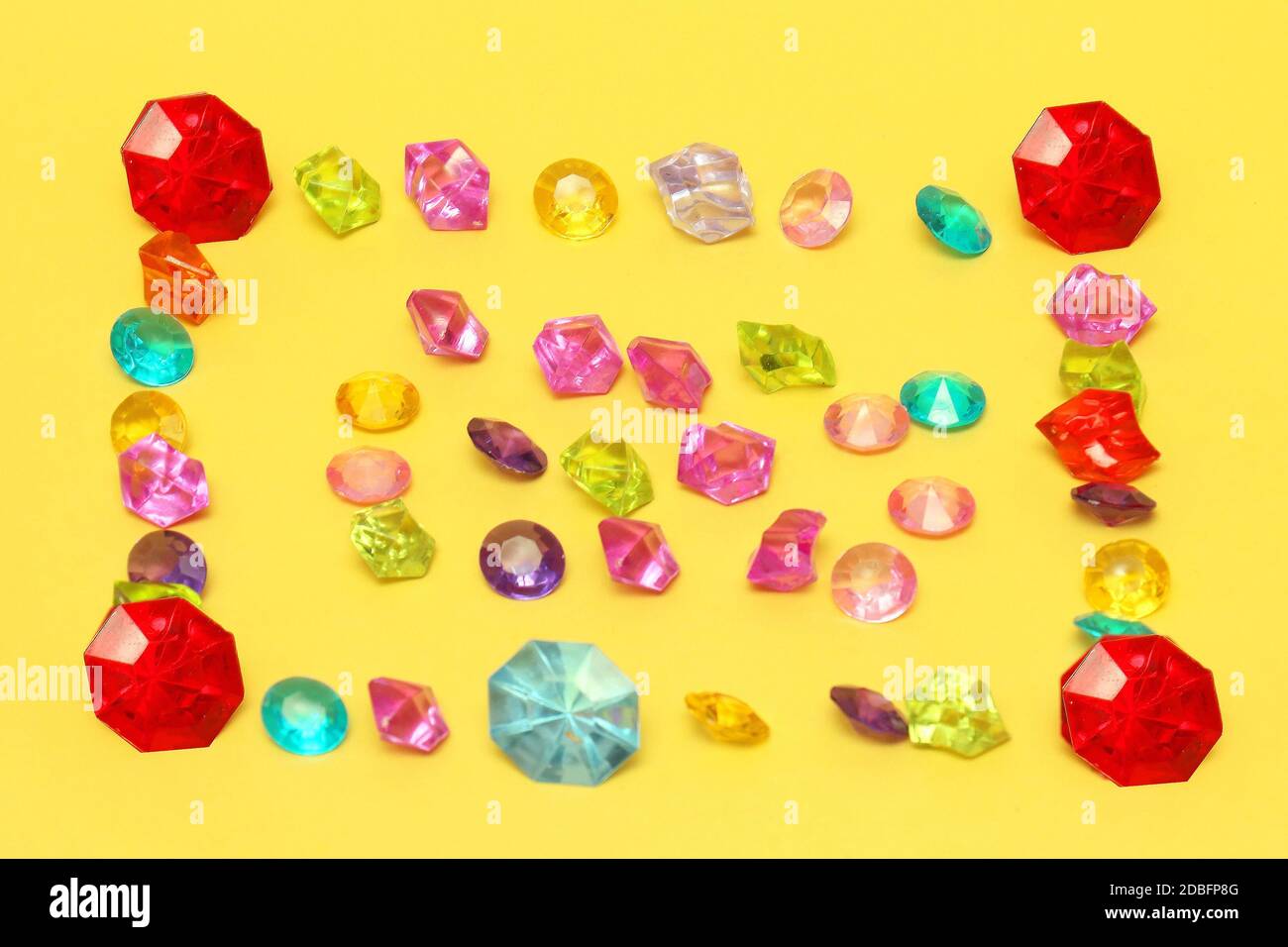 Colorful sparkling diamonds stones on yellow background Stock Photo - Alamy