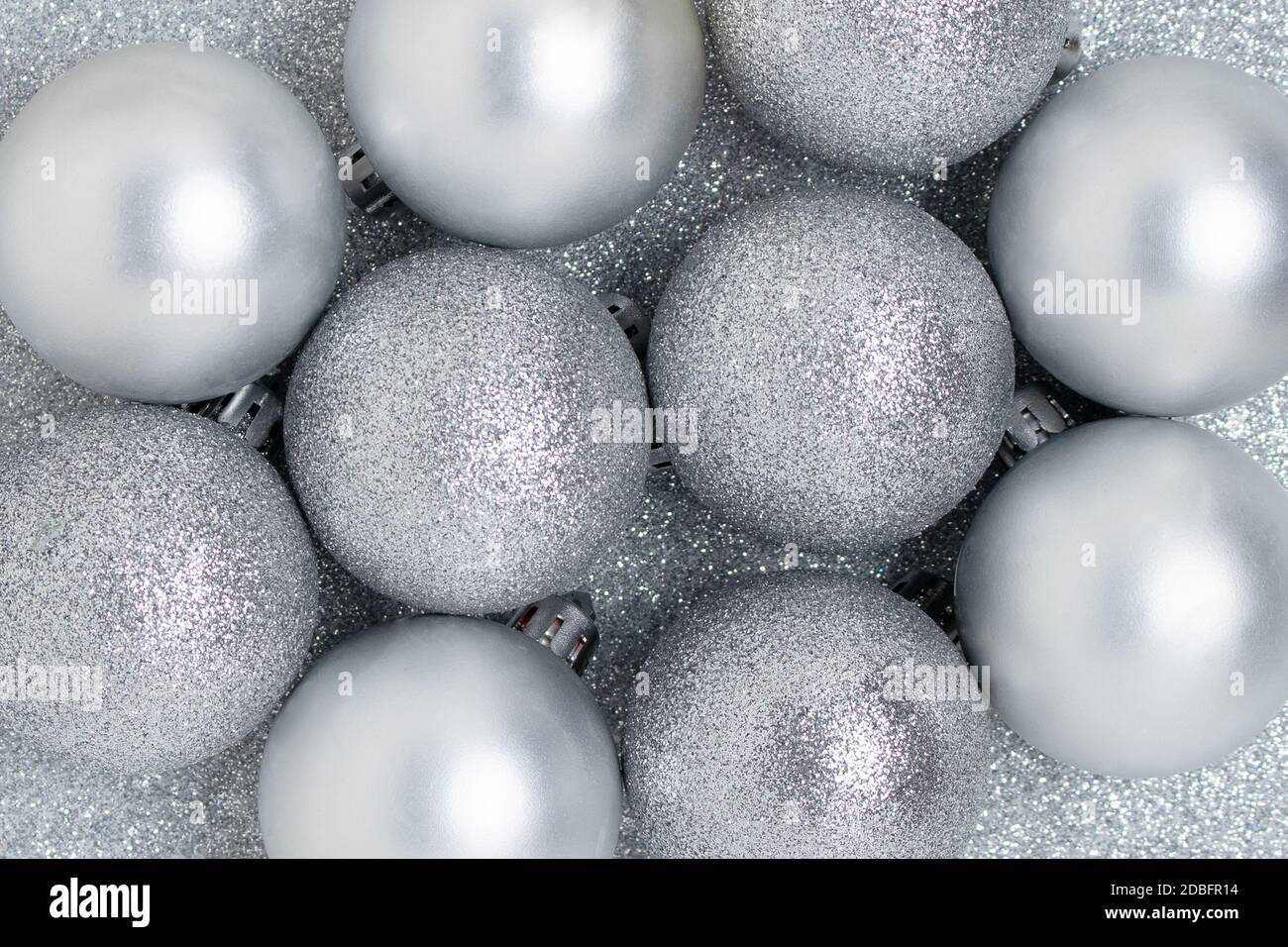 Christmas balls texture on a silver glittering background. Monochrome ...