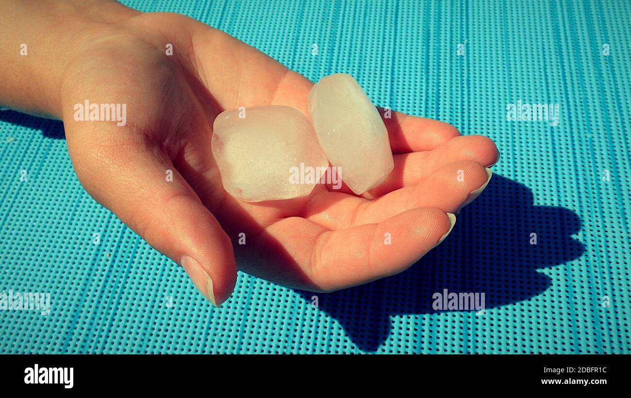 Ice cubes on a hand Stock Photo - Alamy