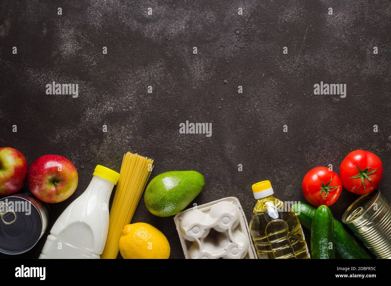 Various groceries on dark concrete background. Food delivery concept ...