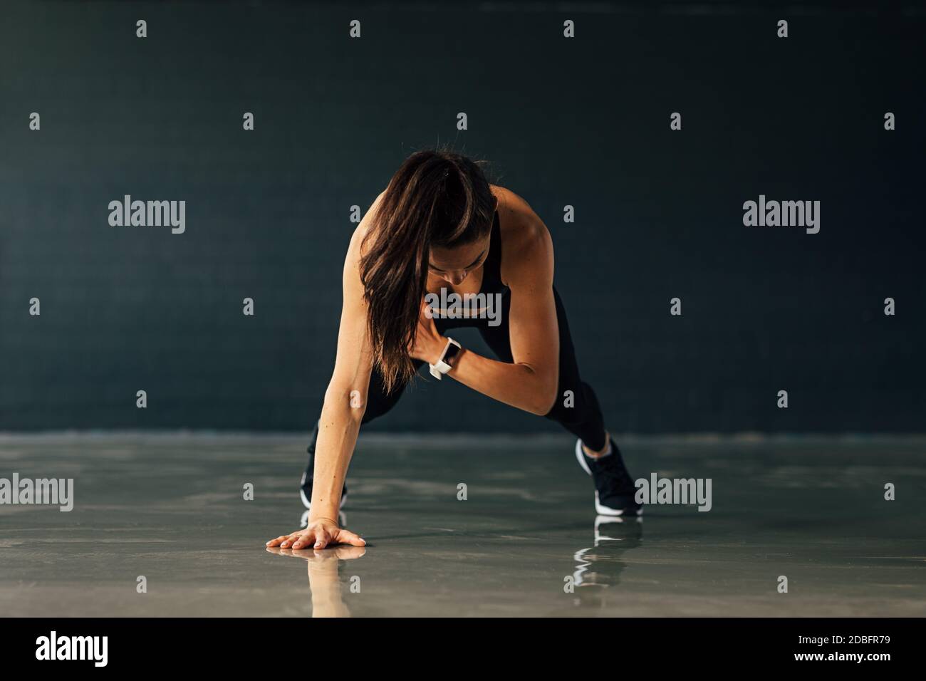 Young muscular woman doing push ups exercises in gym Stock Photo - Alamy