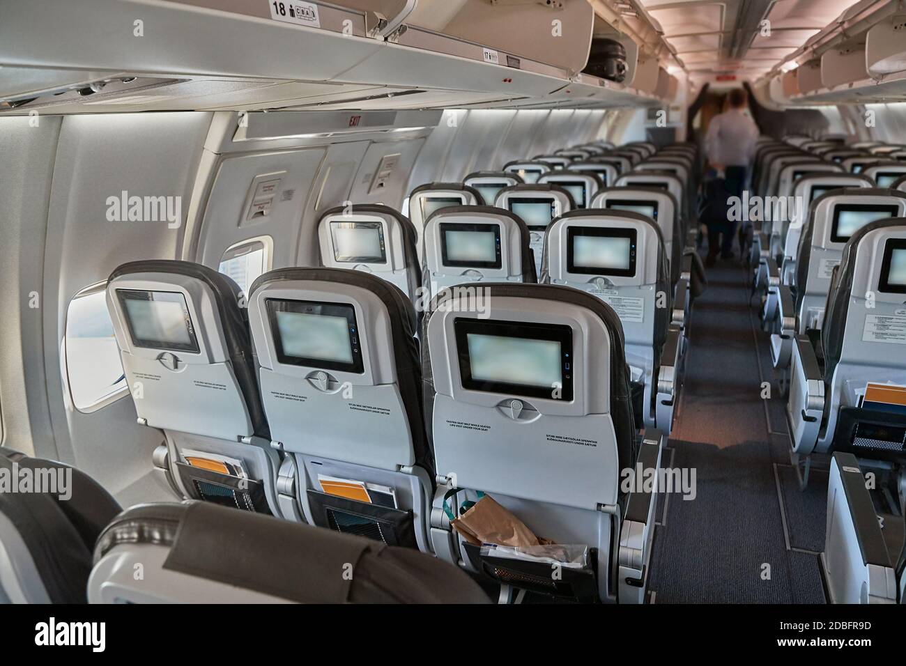 Airplane cabin interrior unboarding after arrival Stock Photo - Alamy