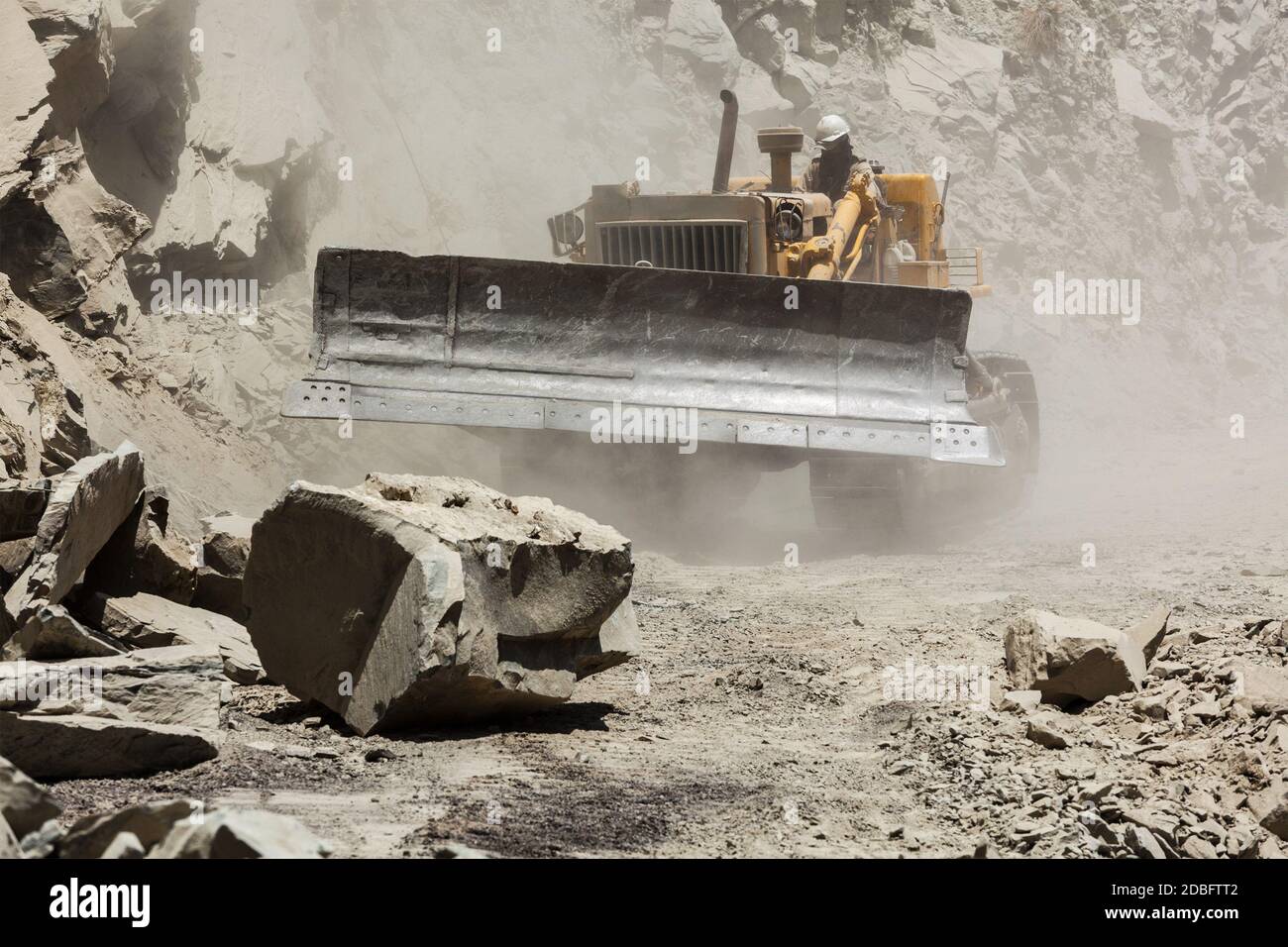 Bulldozer cleaning landslide from road in Himalayas. Himachal Pradesh ...