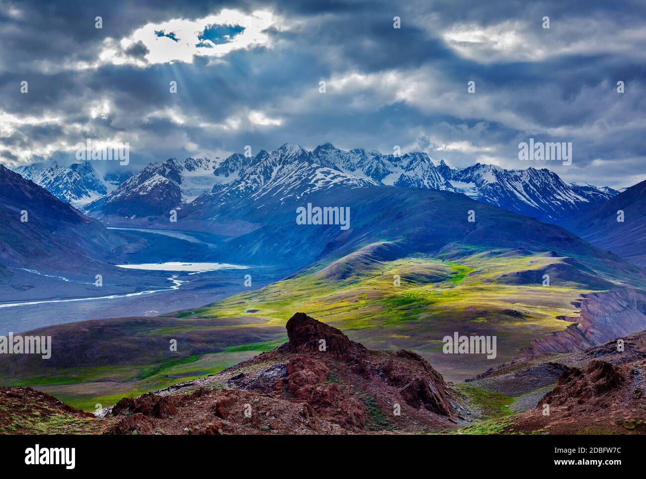 Himalayan landscape near Chandra Tal lake with sun rays coming through ...