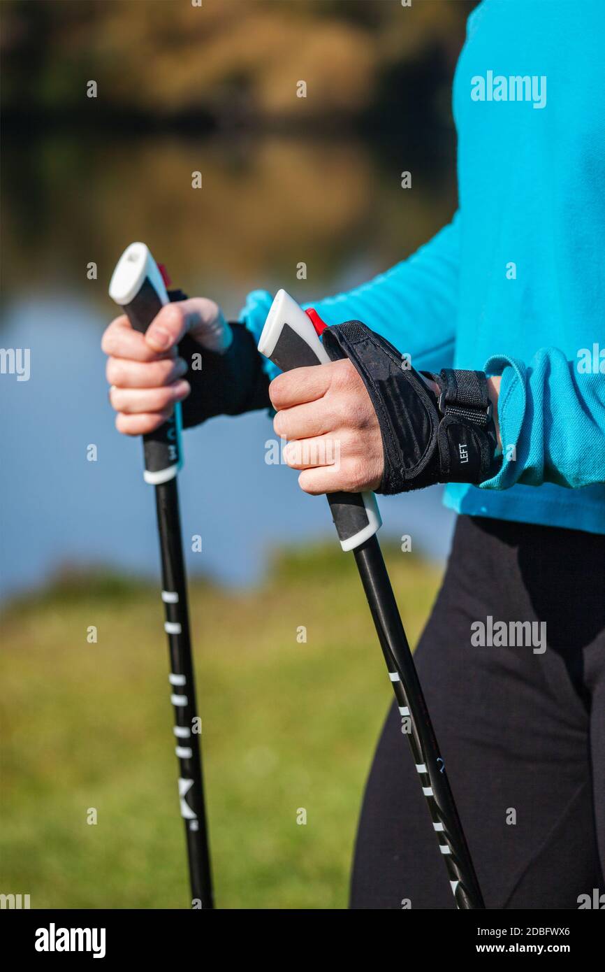 Nordic walking exercise adventure hiking concept - closeup of woman's ...