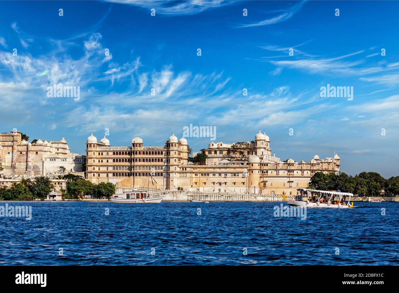 India luxury tourism concept background - Udaipur City Palace from Lake ...