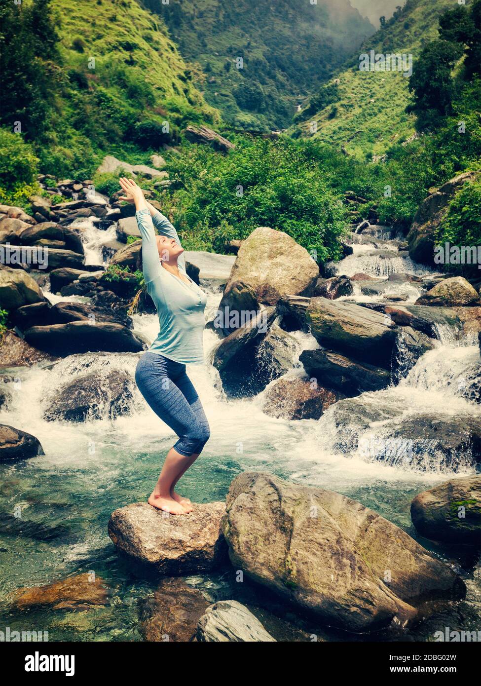 Vintage retro effect hipster style image of sporty fit woman doing yoga ...