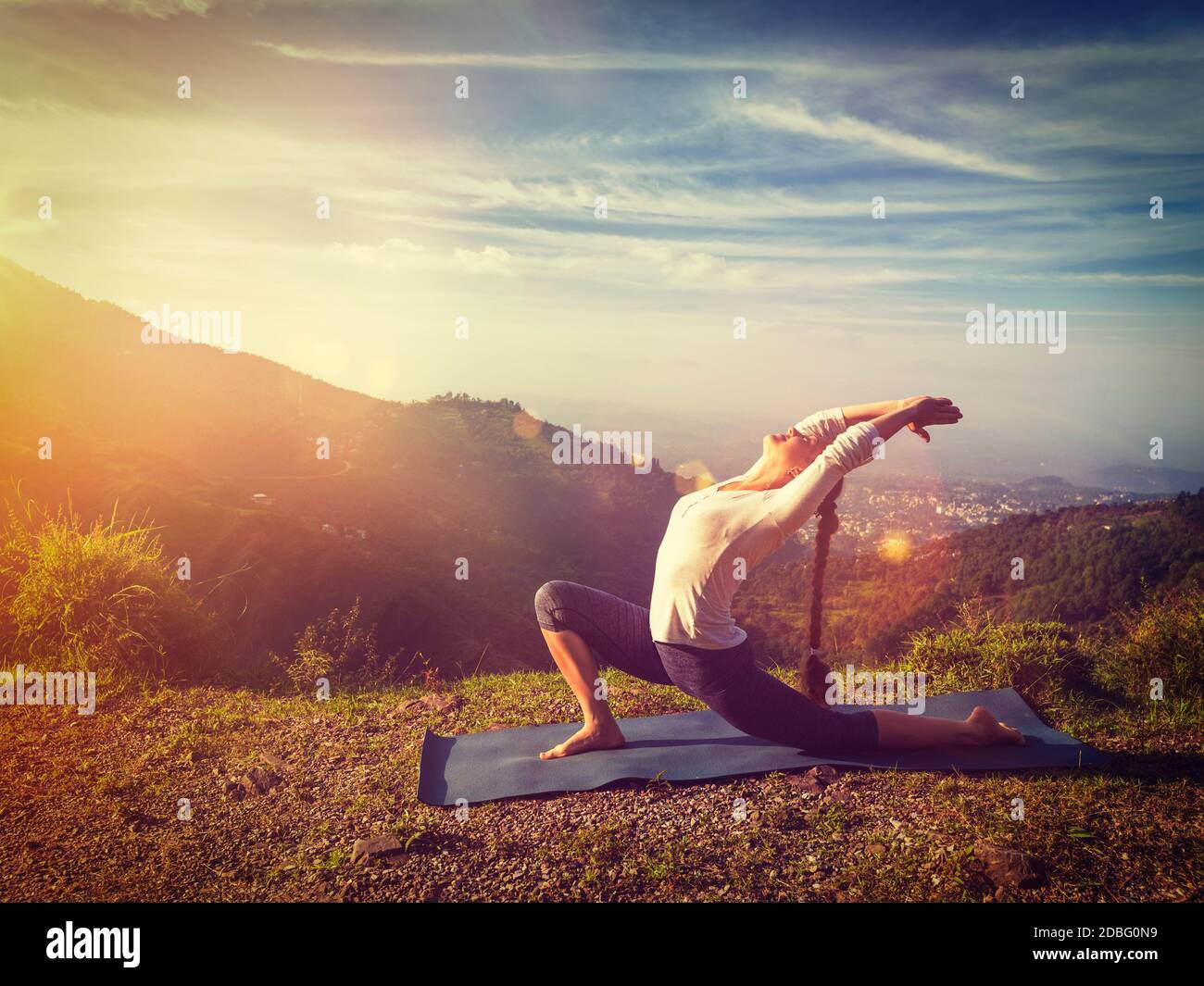 Yoga outdoors - sporty fit woman practices yoga Anjaneyasana - low ...