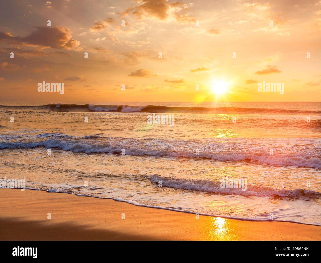 Sunrise with rising sun on morning beach. With lens flare and light ...