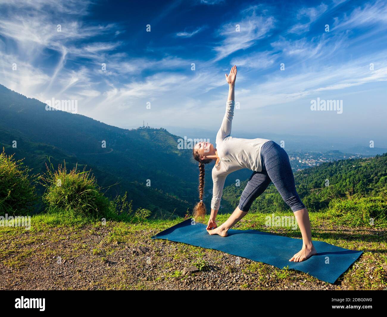 Woman doing Ashtanga Vinyasa yoga asana Utthita trikonasana - extended ...