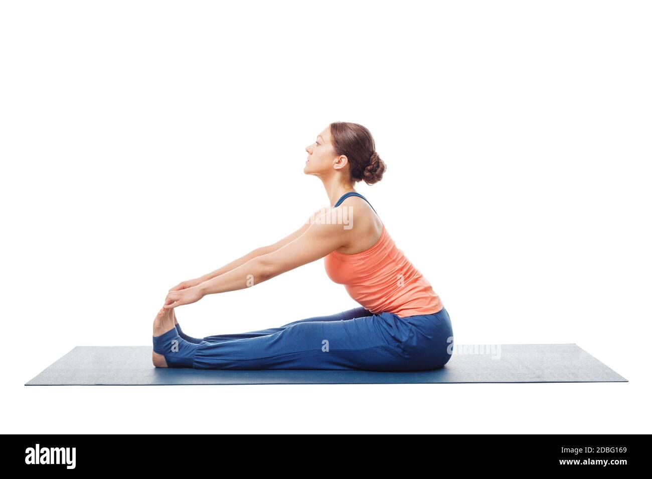 Woman doing Ashtanga Vinyasa Yoga asana Paschimottanasana - seated forward bend pose isolated on ...