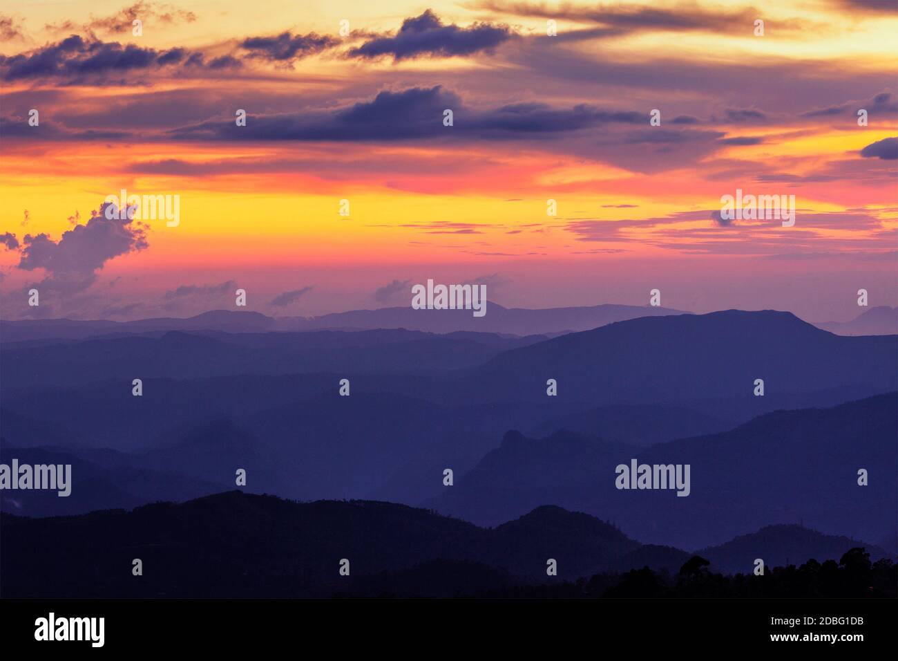Silhouettes of hills in valley on sunset. Pothamedu viewpoint, Munnar ...
