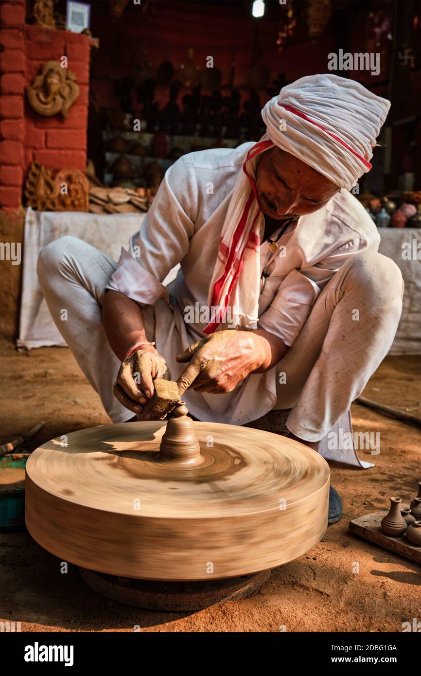 Indian potter at work: throwing the potter's wheel and shaping ceramic ...