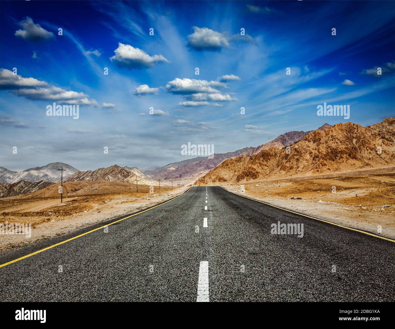 Travel forward concept background - road in Himalayas with mountains and dramatic clouds. Ladakh ...