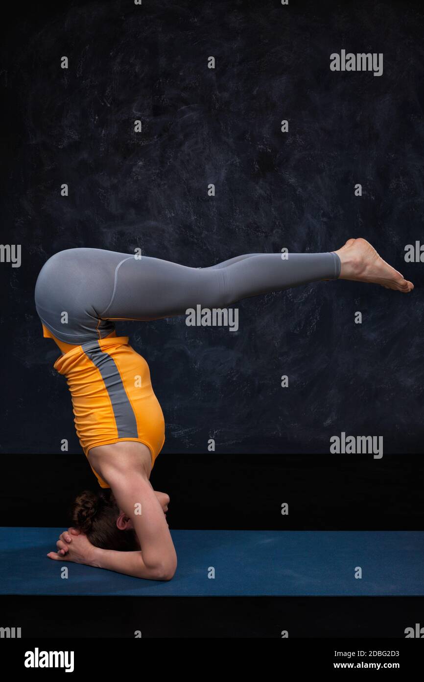 Woman doing Hatha yoga Ashtanga Vinyasa Yoga asana sirsasana ...