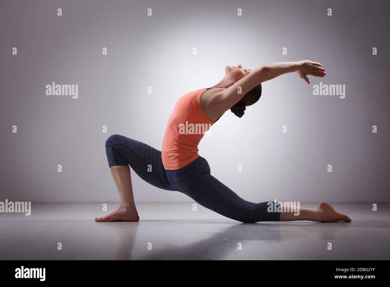 Beautiful sporty fit yogini woman practices yoga asana Anjaneyasana ...