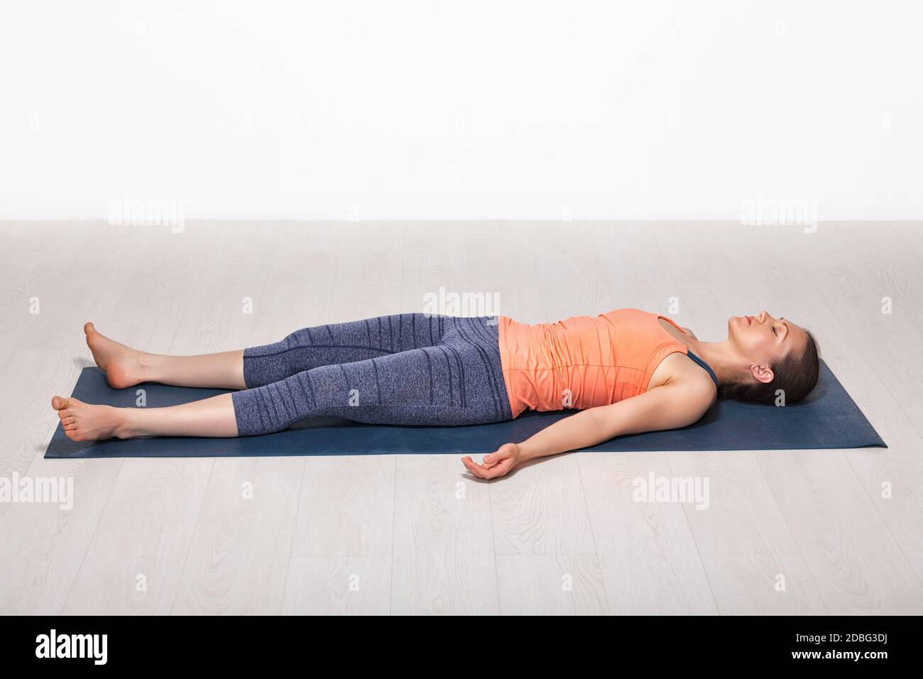 Beautiful sporty fit yogini woman relaxes in yoga asana Savasana ...