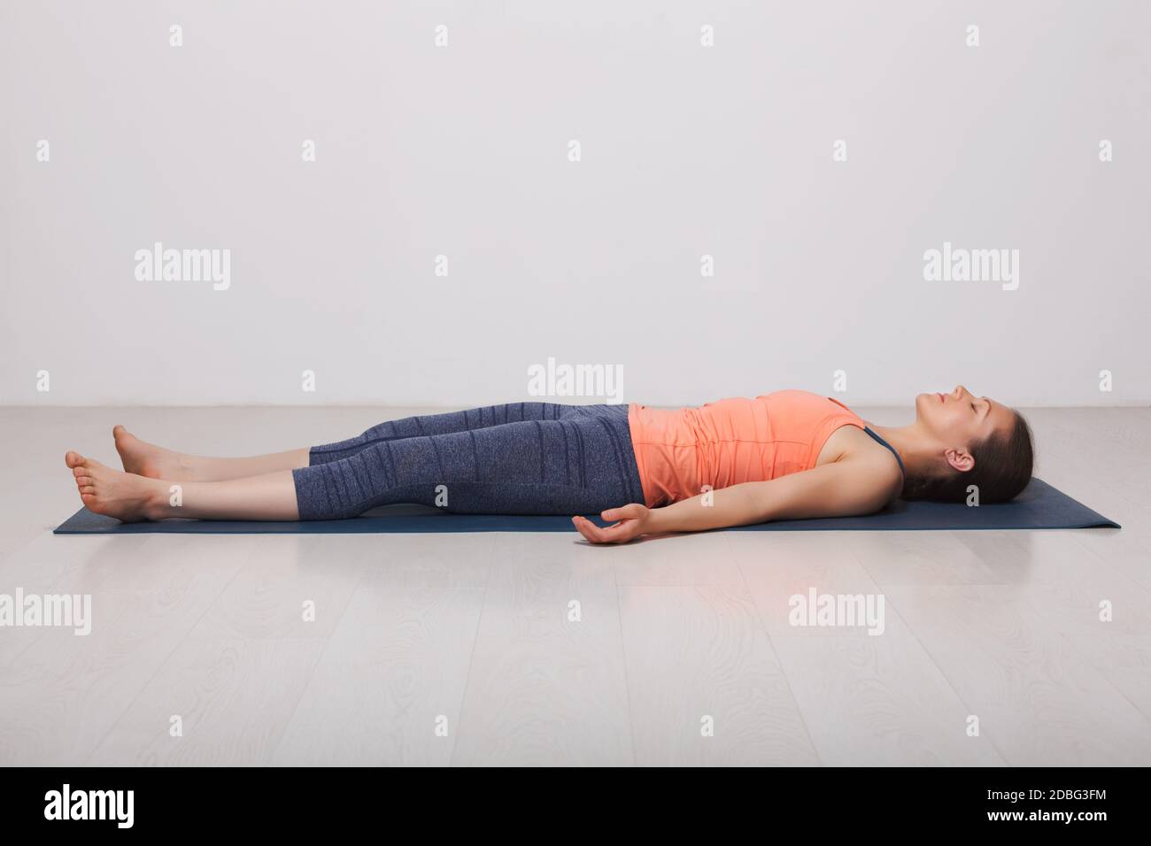 Beautiful sporty fit yogini woman relaxes in yoga asana Savasana ...