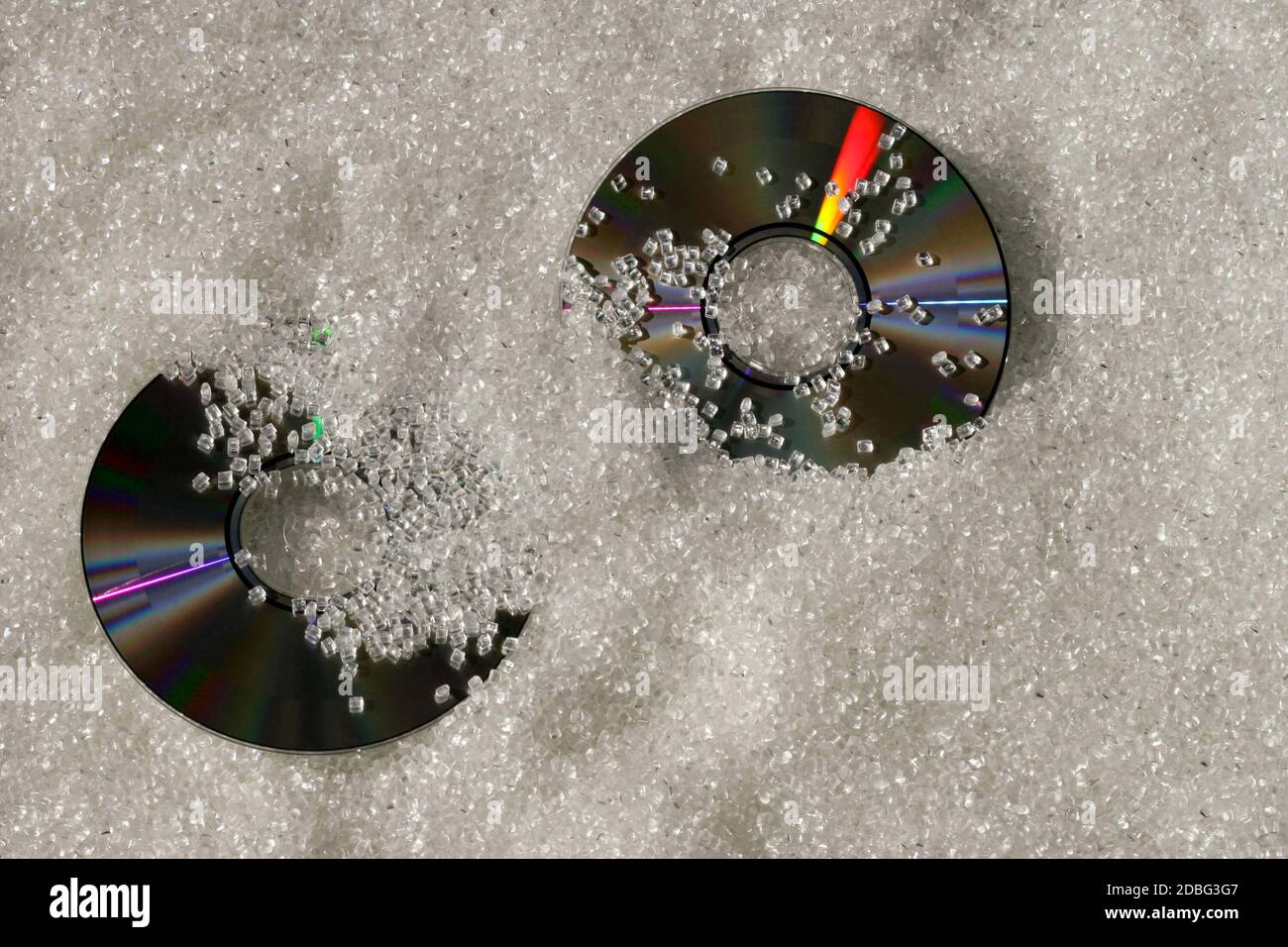 Two DVDs with background of plastic granulate material Stock Photo - Alamy
