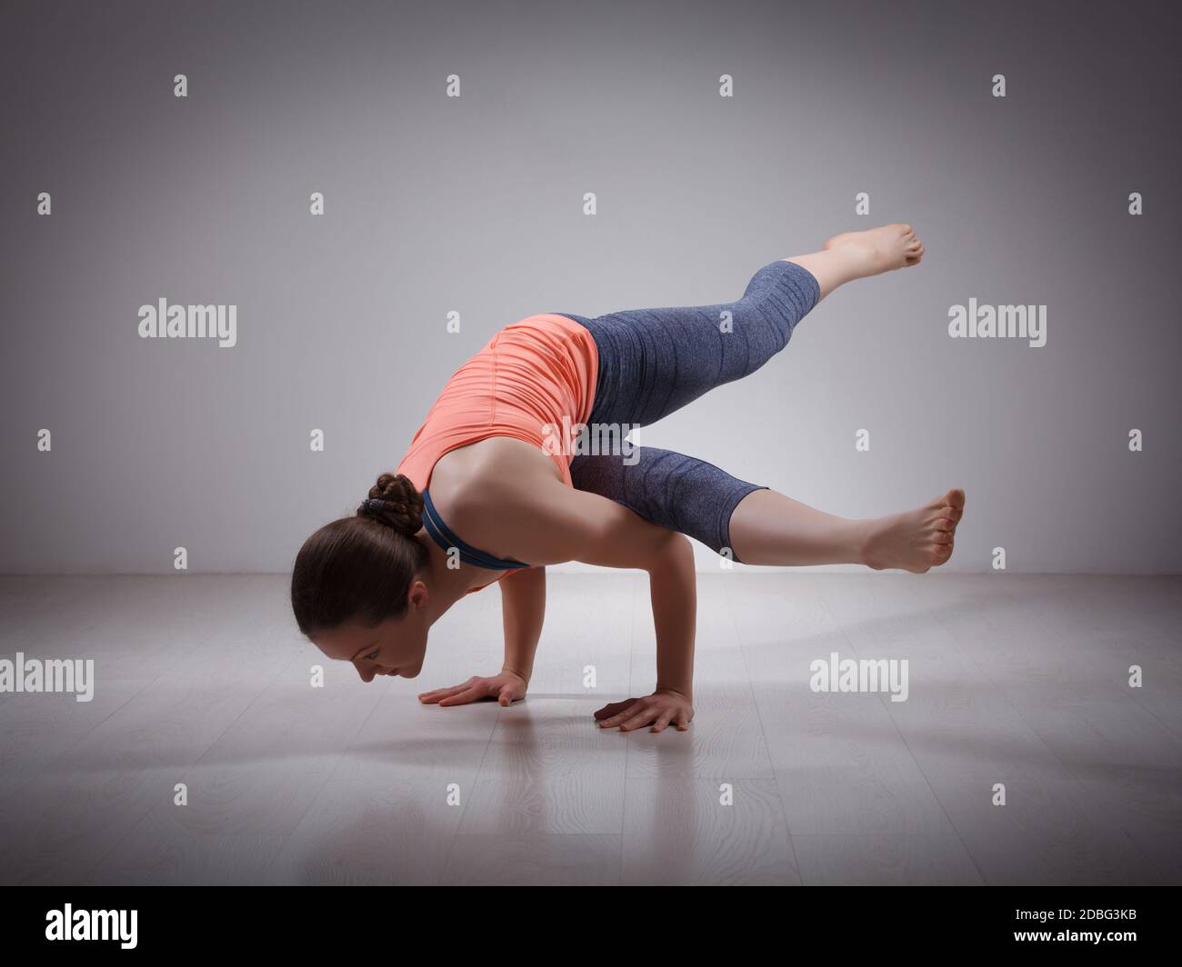 Beautiful sporty fit yogini woman practices yoga asana eka pada ...