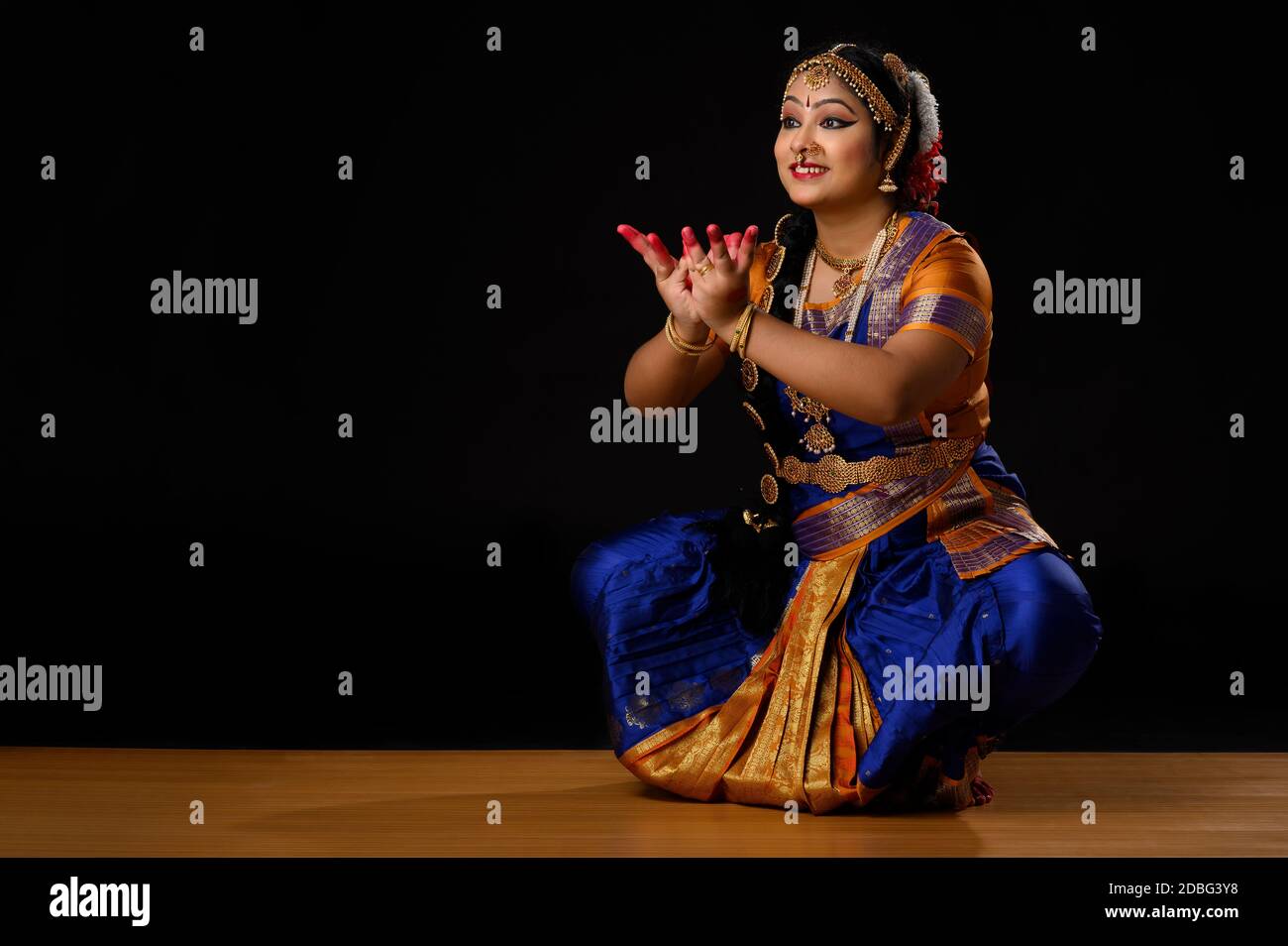 Kuchipudi dancer offering worshiping by offering a flower through her ...