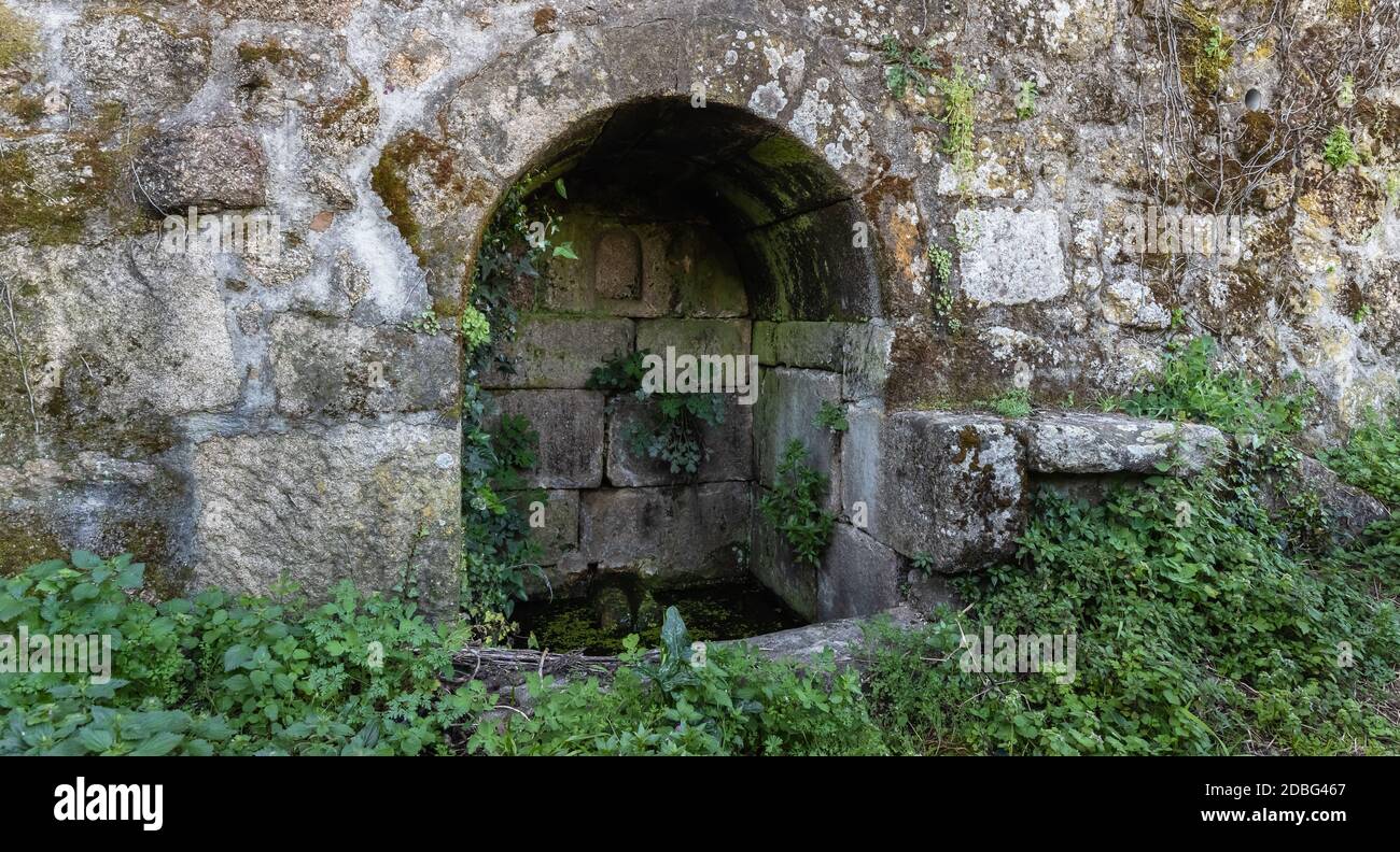 old stone water source in portugal - ancient well in the countryside ...