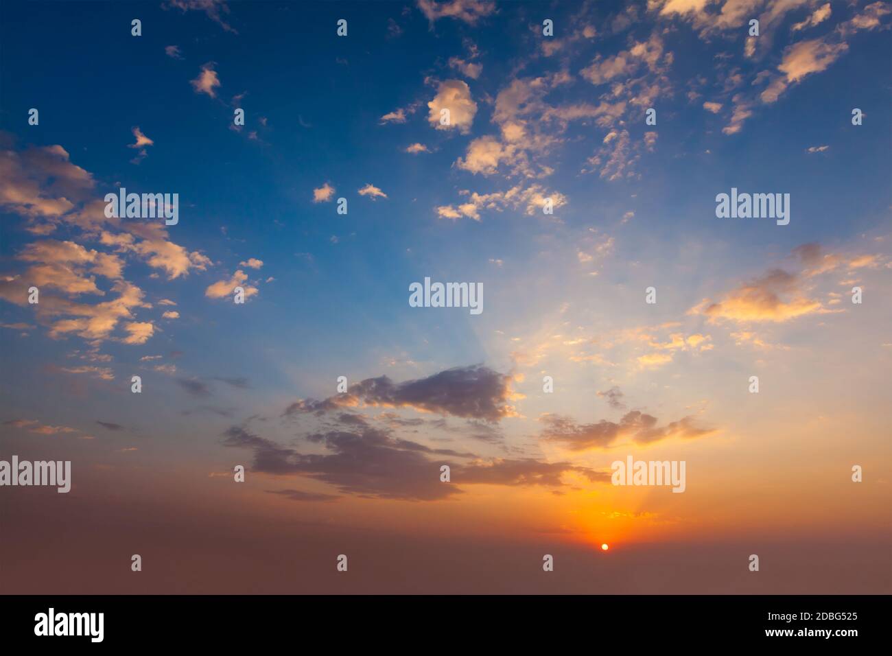 Evening sunset sky with sun and dramatic clouds Stock Photo - Alamy