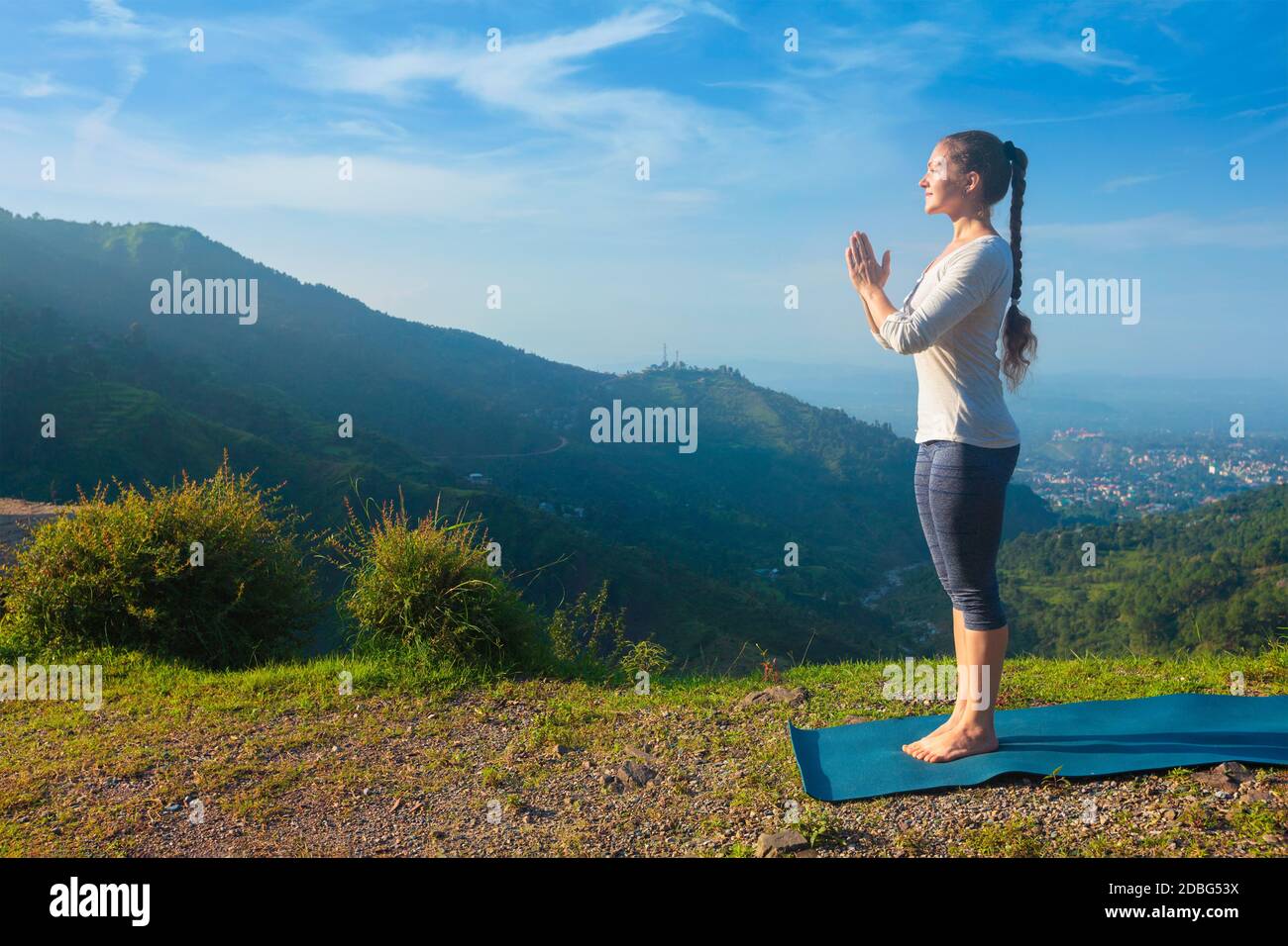 Woman doing Ashtanga Vinyasa Yoga asana Tadasana Samasthiti yoga ...