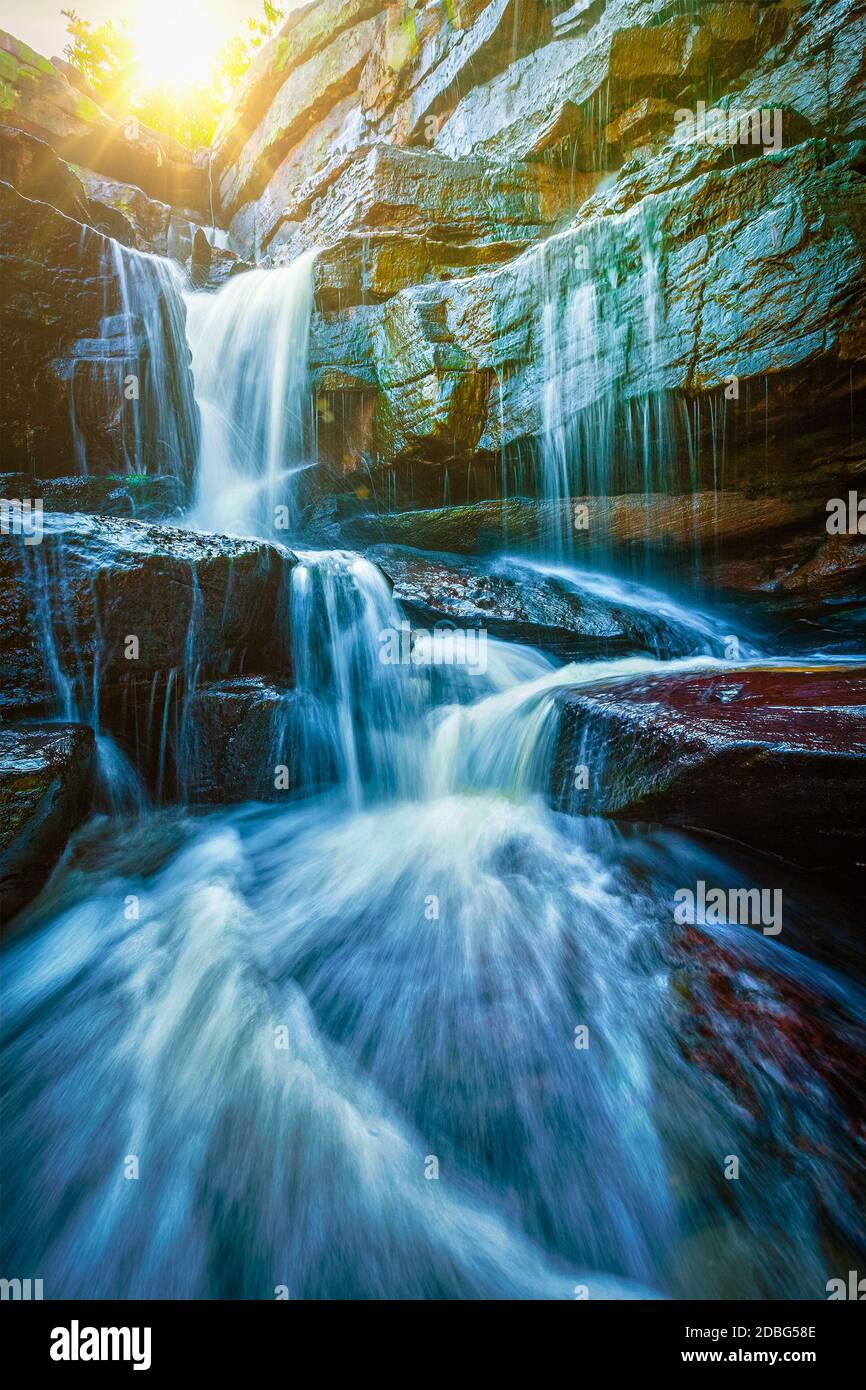 Tropical waterfall with sun rays. With lens flare and light leak Stock ...