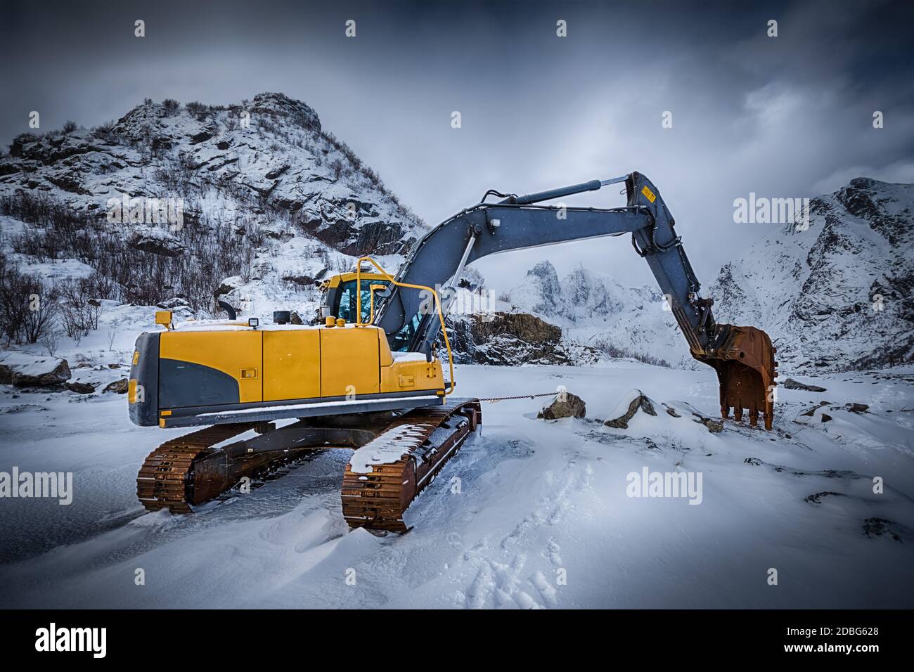 Old excavator with excavator bucket in winter. Road construction in ...